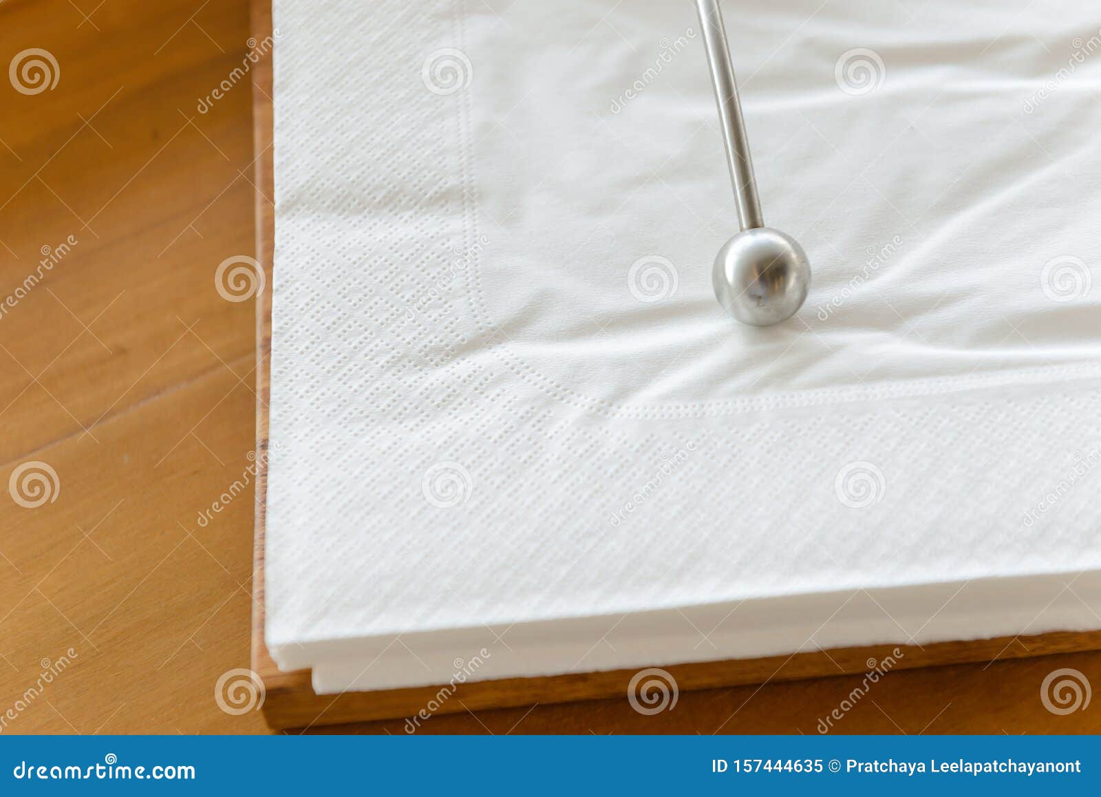 Metal Paperweight on Stack of White Square Paper Napkin. Modern Paper ...