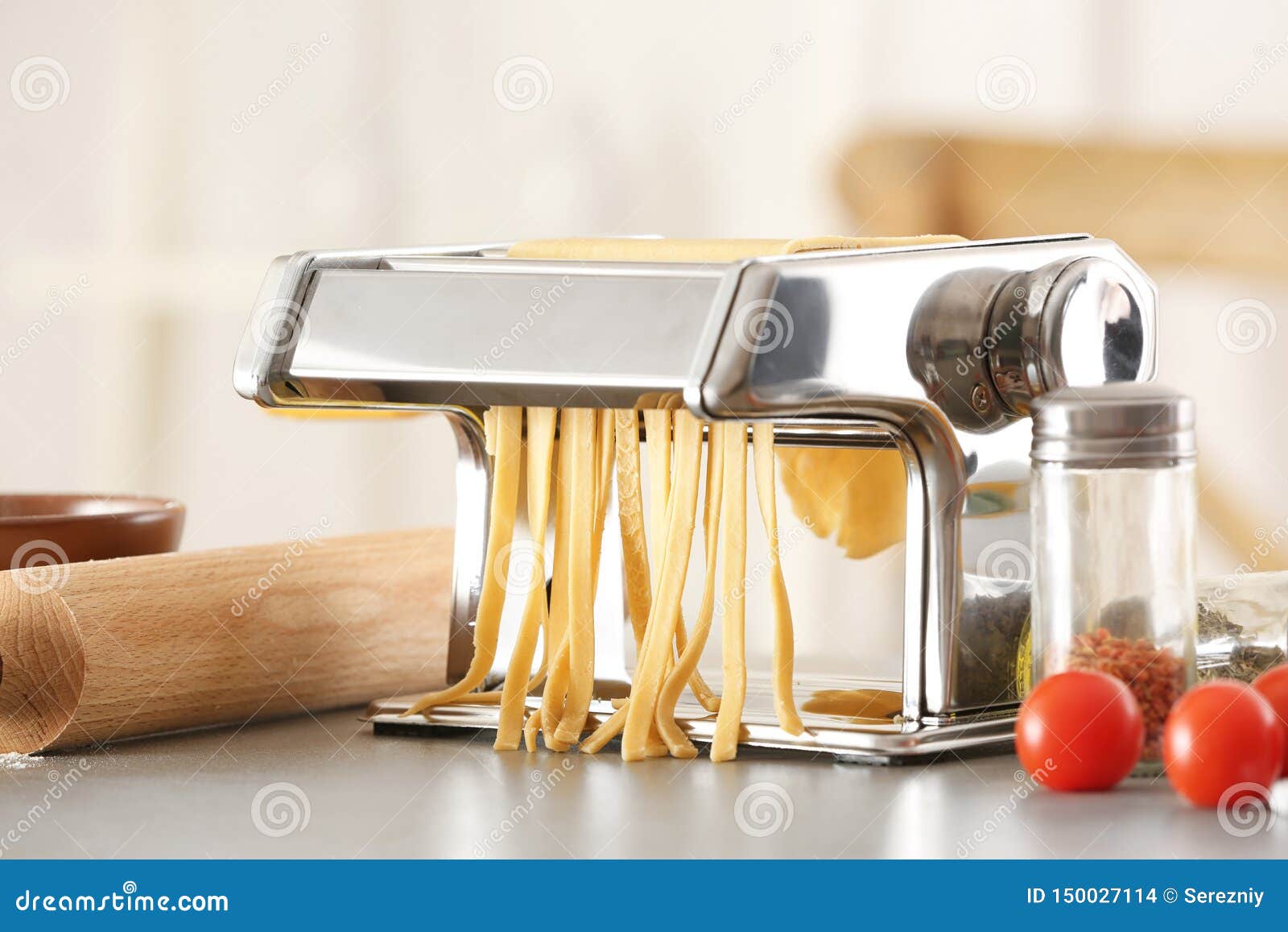 Metal Pasta Maker with Dough on Kitchen Table Stock Photo - Image of ...