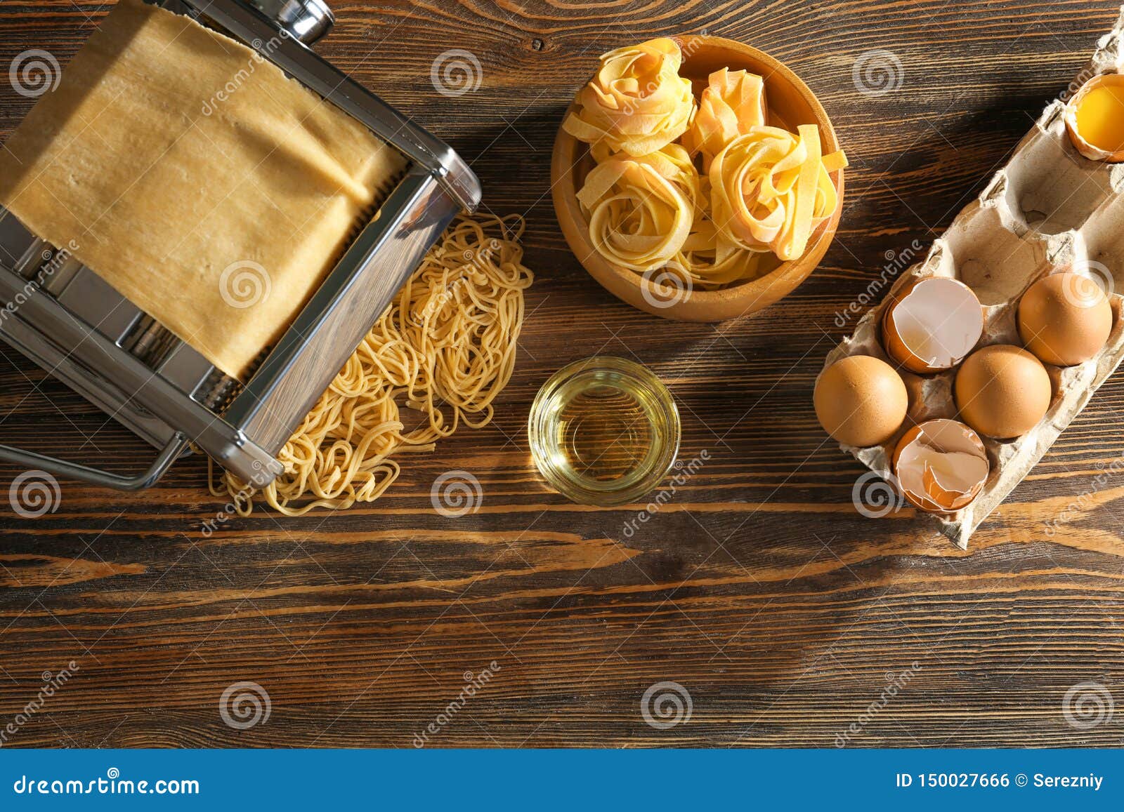 Metal Pasta Maker with Dough and Products on Kitchen Table, Top View ...