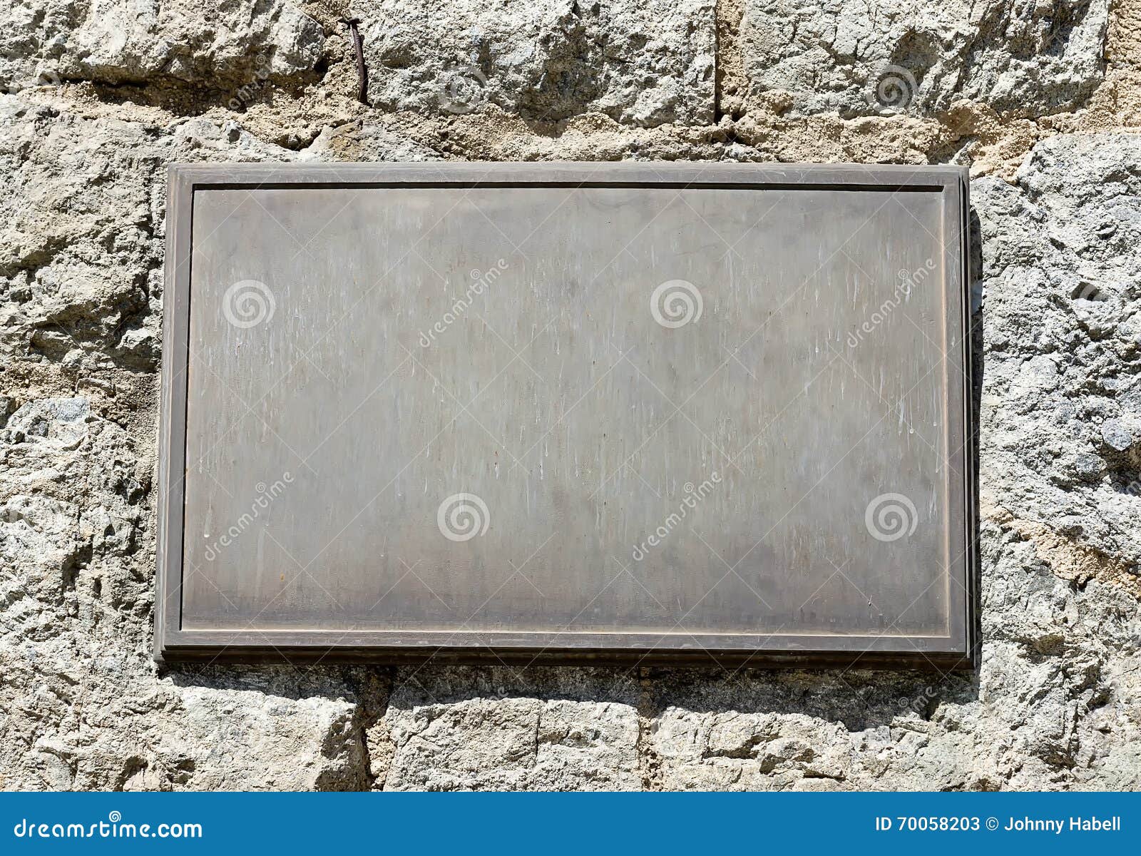Metal Plaque on Stone Wall stock image. Image of bronze - 70058203