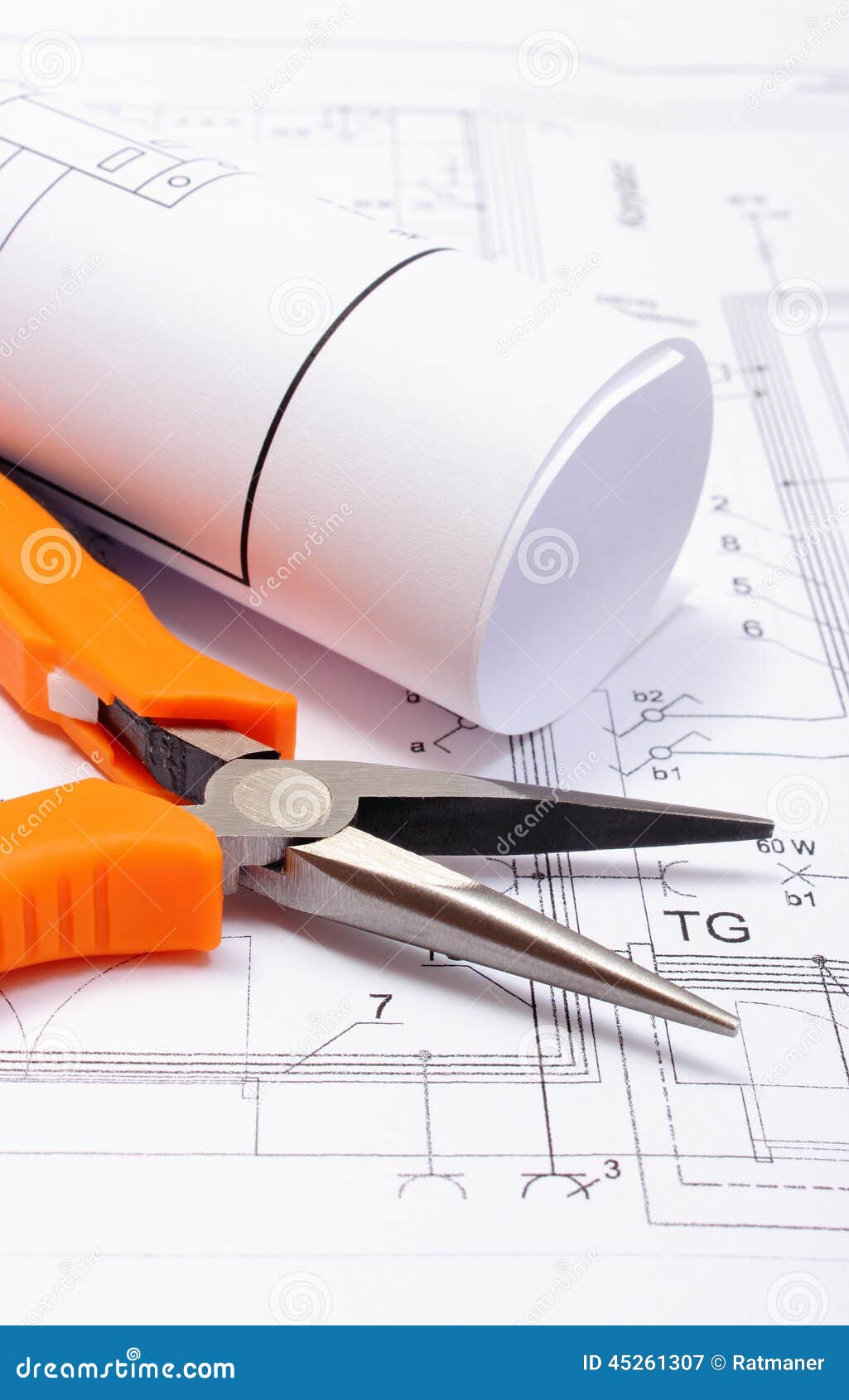 Metal Pliers and Rolled Electrical Diagram on Construction Drawing of ...