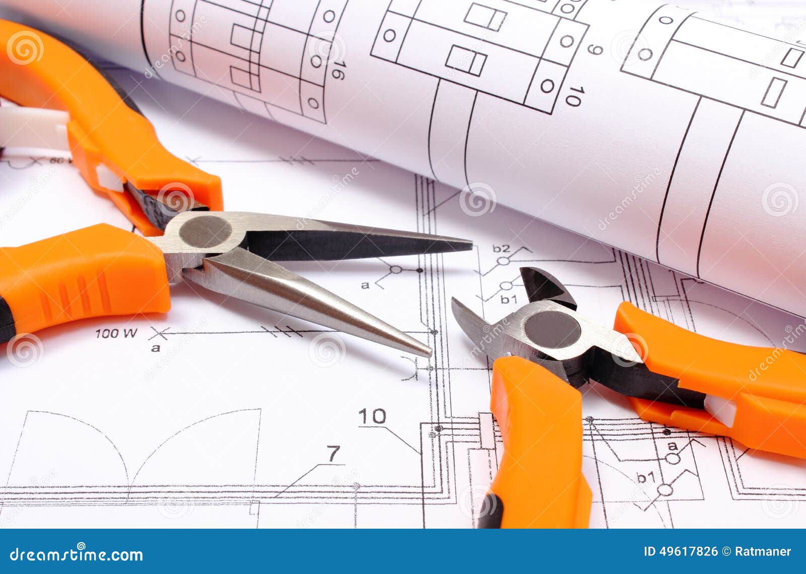 Metal Pliers and Rolled Electrical Diagram on Construction Drawing of ...