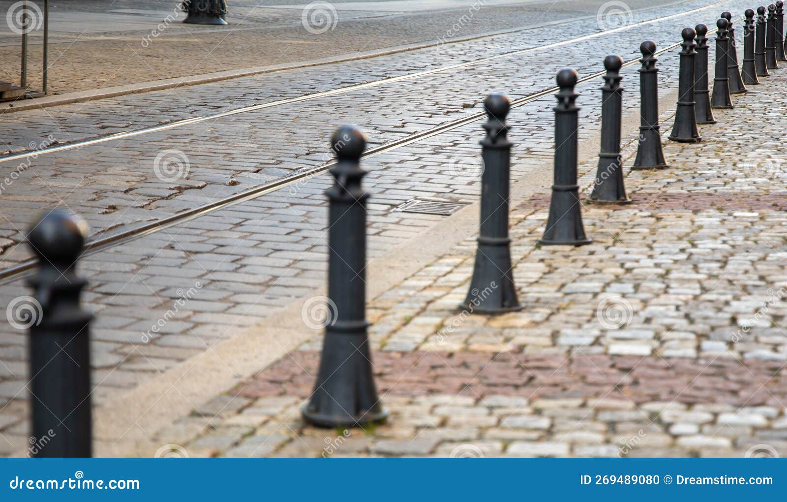 Black Posts Separating Paved Street and Path Stock Photo - Image of ...
