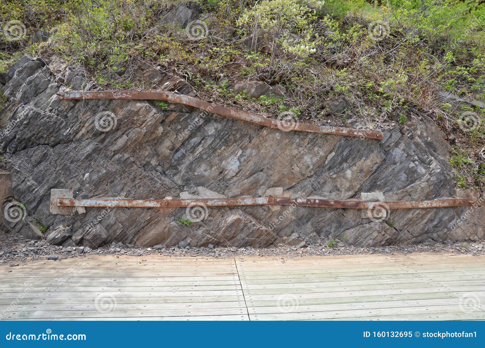 Metal Railing on Rocks and Wood Floor Stock Image - Image of rust, deck ...