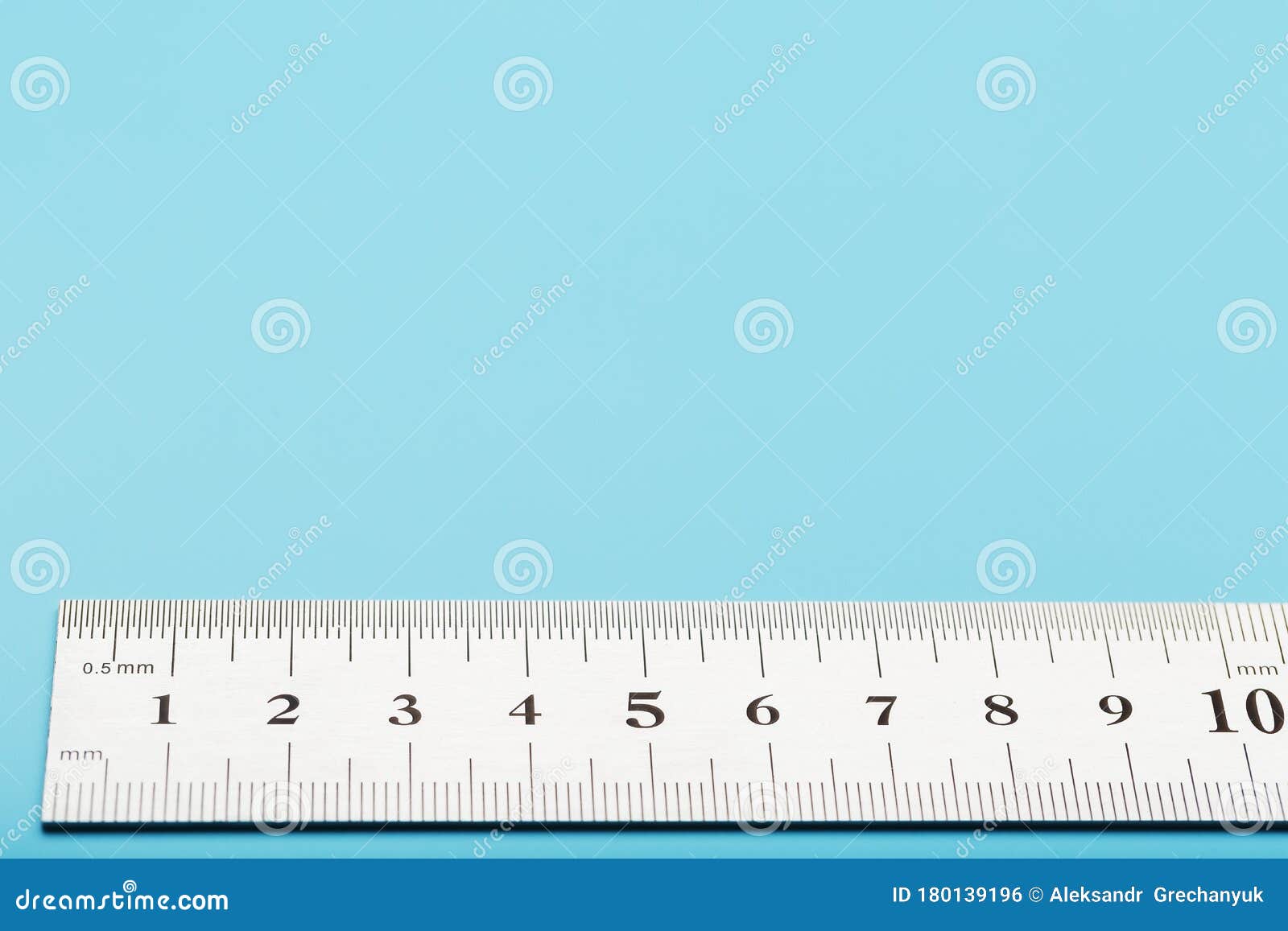 A Metal Ruler with a Scale on a Blue Background is a Superscape with a ...