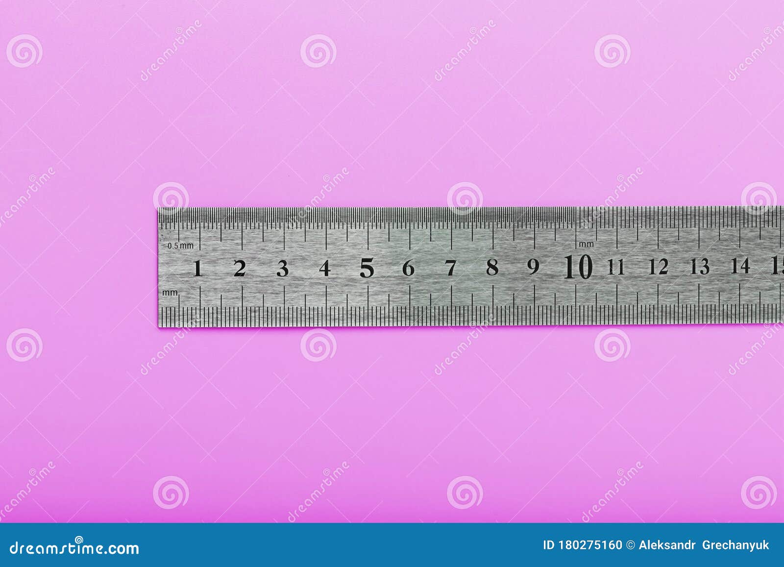 A Metal Ruler with a Scale on a Pink Background is a Superscape with a ...