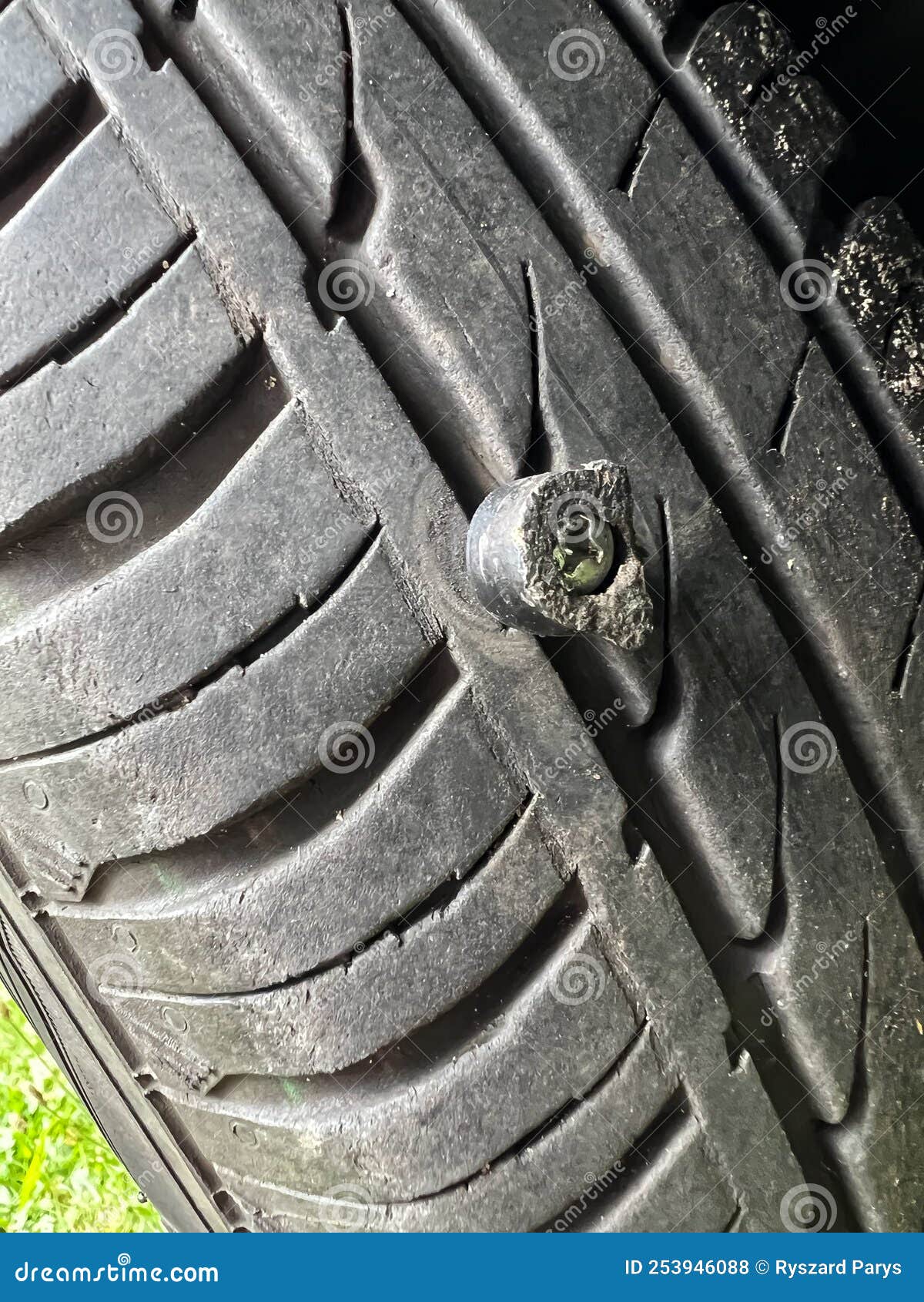 A Metal Hammered into a Car Tire Stock Photo - Image of wheel ...