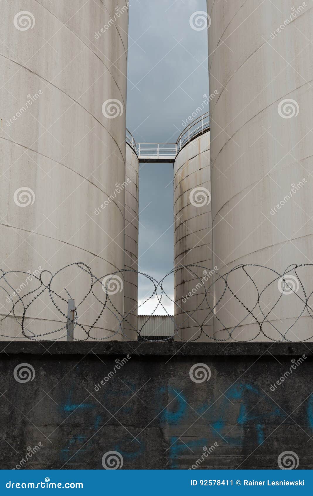 Metal Silo, Store Behind a Concrete Wall with Barbed Wire Stock Image ...