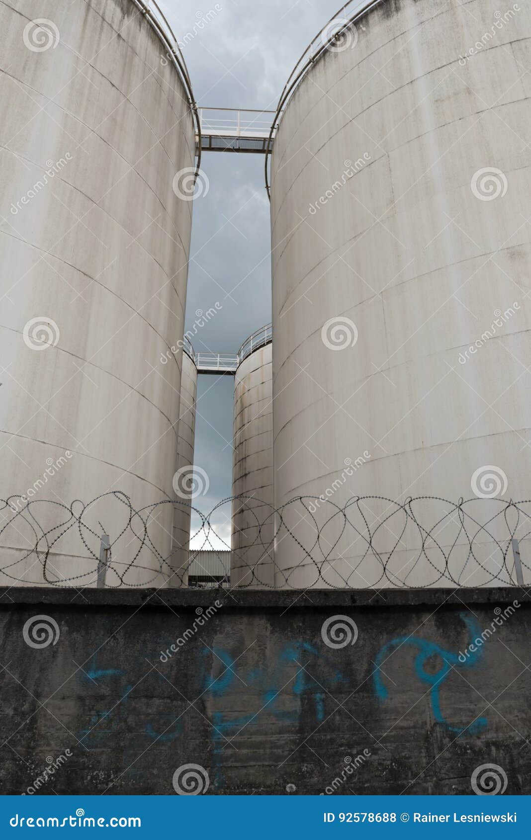 Metal Silo, Store Behind a Concrete Wall with Barbed Wire Stock Photo ...