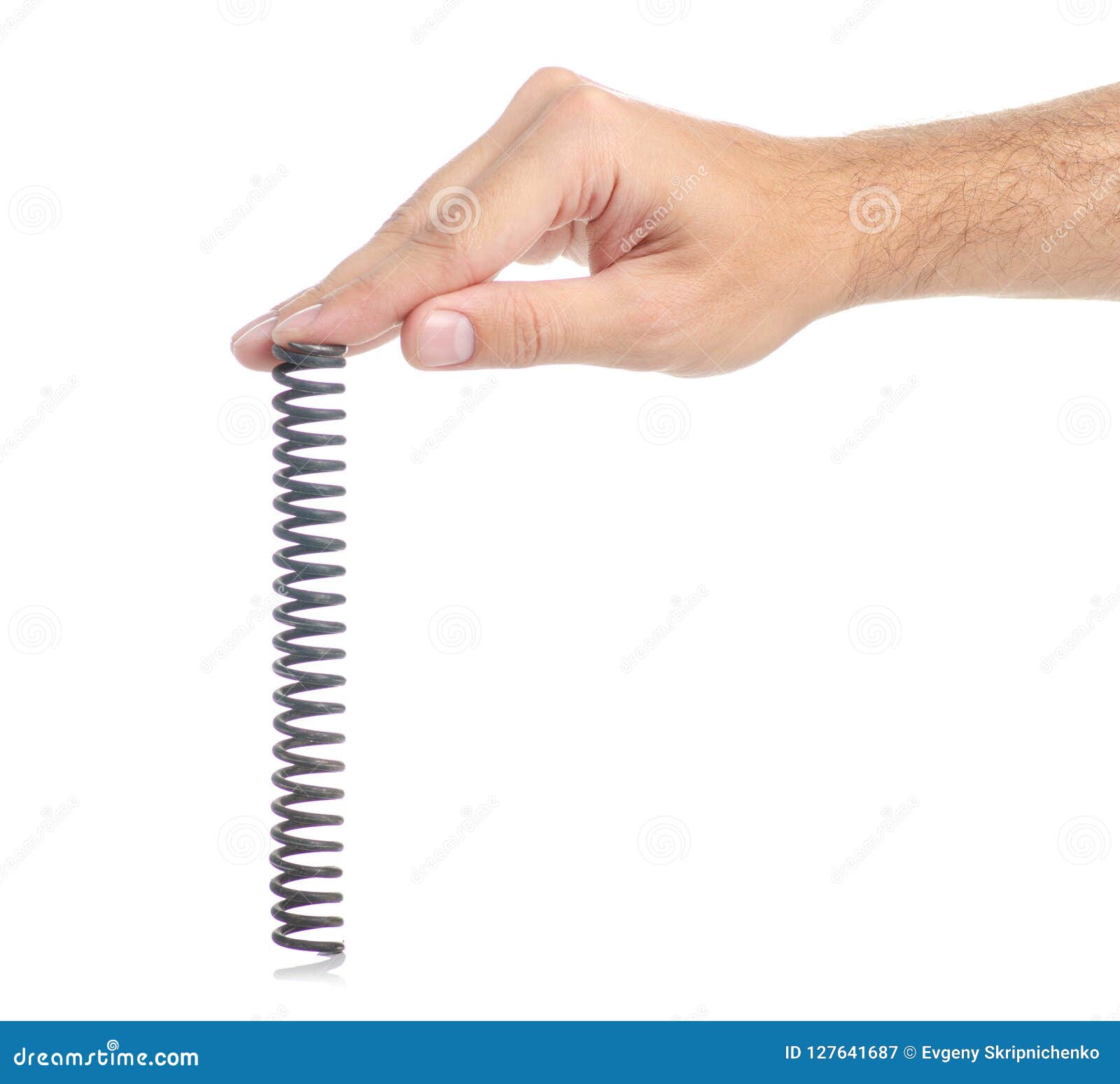 Metal spring in a hand stock image. Image of conceptual - 127641687