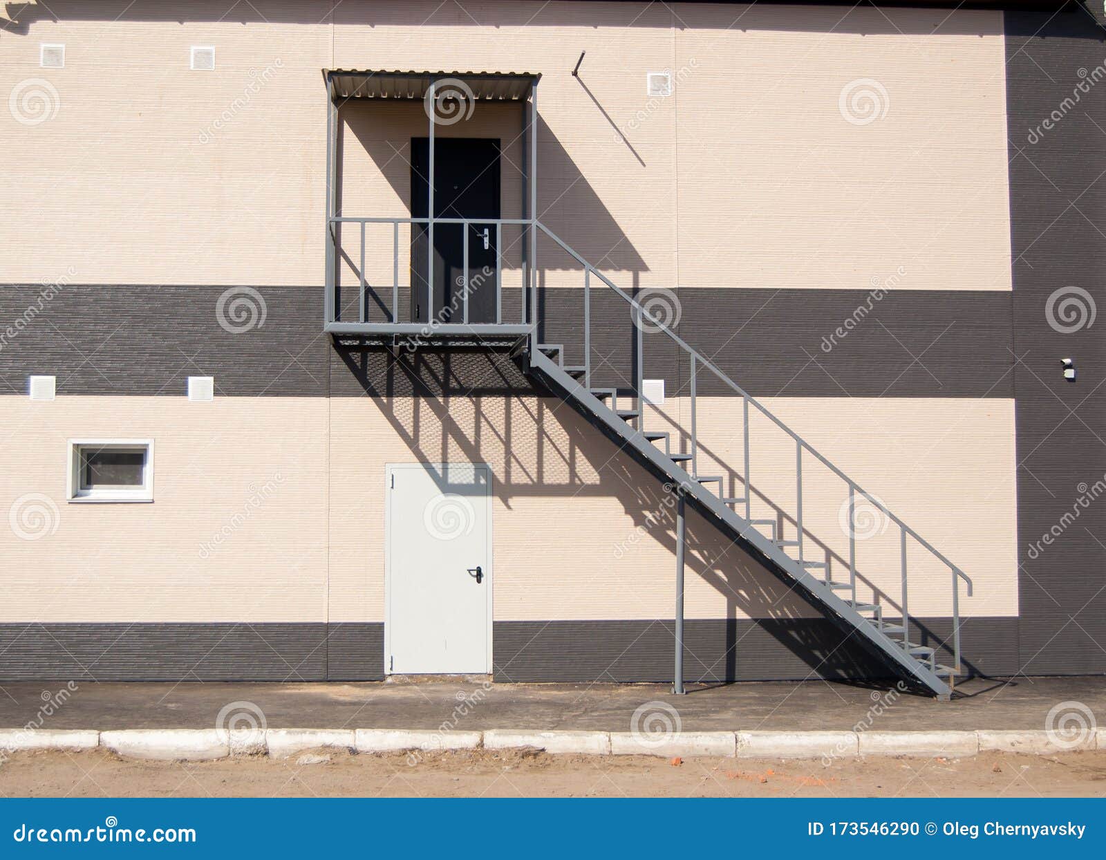 A Metal Staircase Leading To the Second Floor Along the Outer Wall of ...