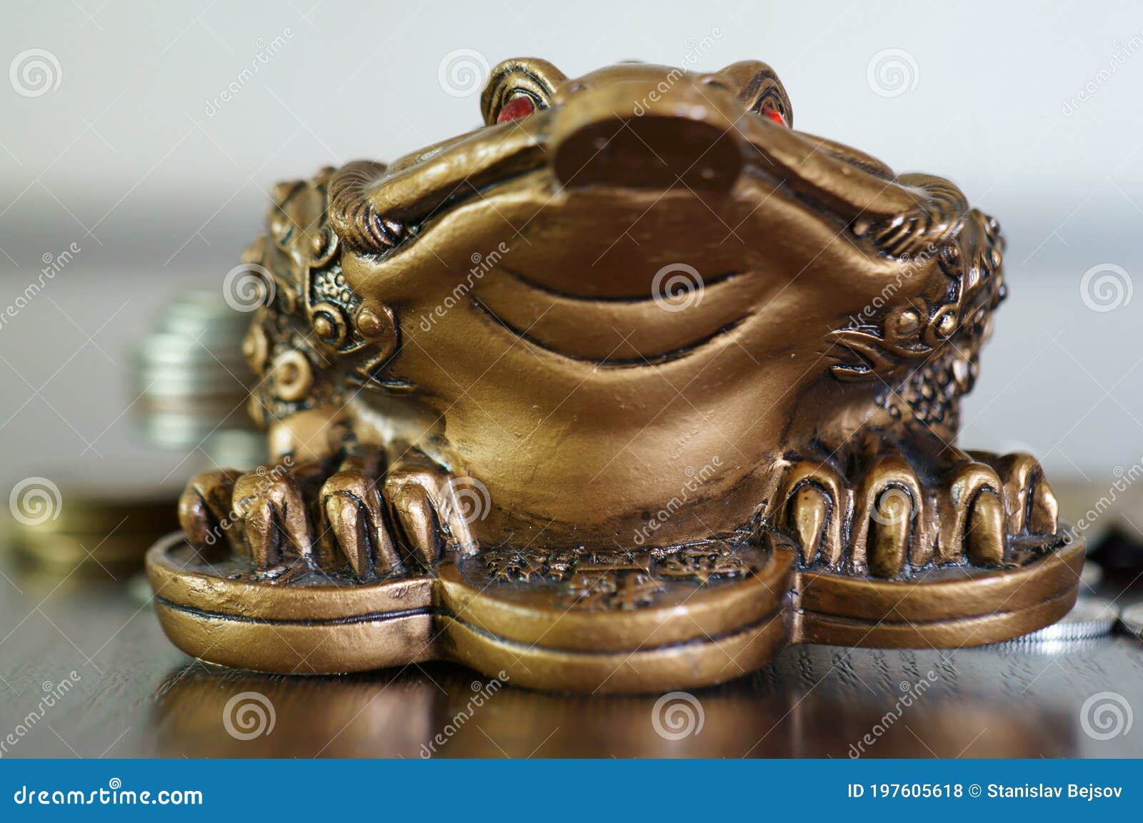 A Metal Toad Next To a Stack of Coins. Stock Photo - Image of frog ...