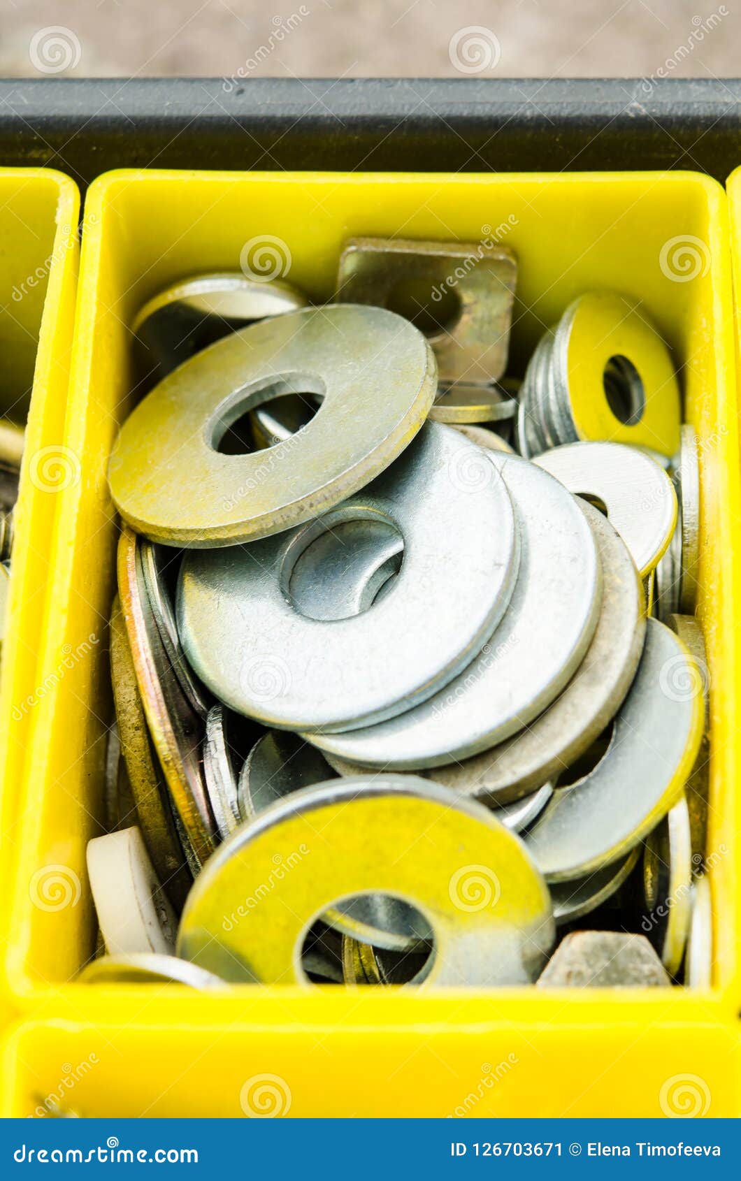 Metal washer in yellow box stock image. Image of parts - 126703671