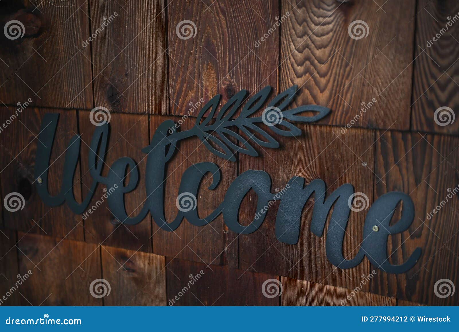 Metal Welcome Sign on a Wood Shingle Wall Stock Photo - Image of ...