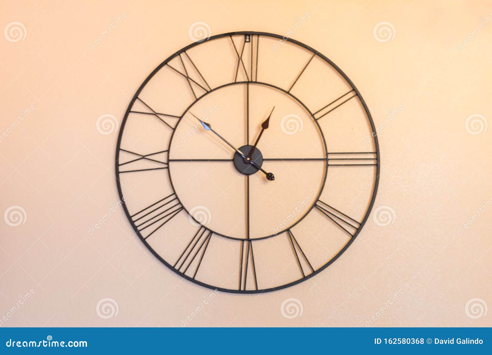 Metal Wire Clock Hanging on Orange Wall Stock Photo - Image of brown ...