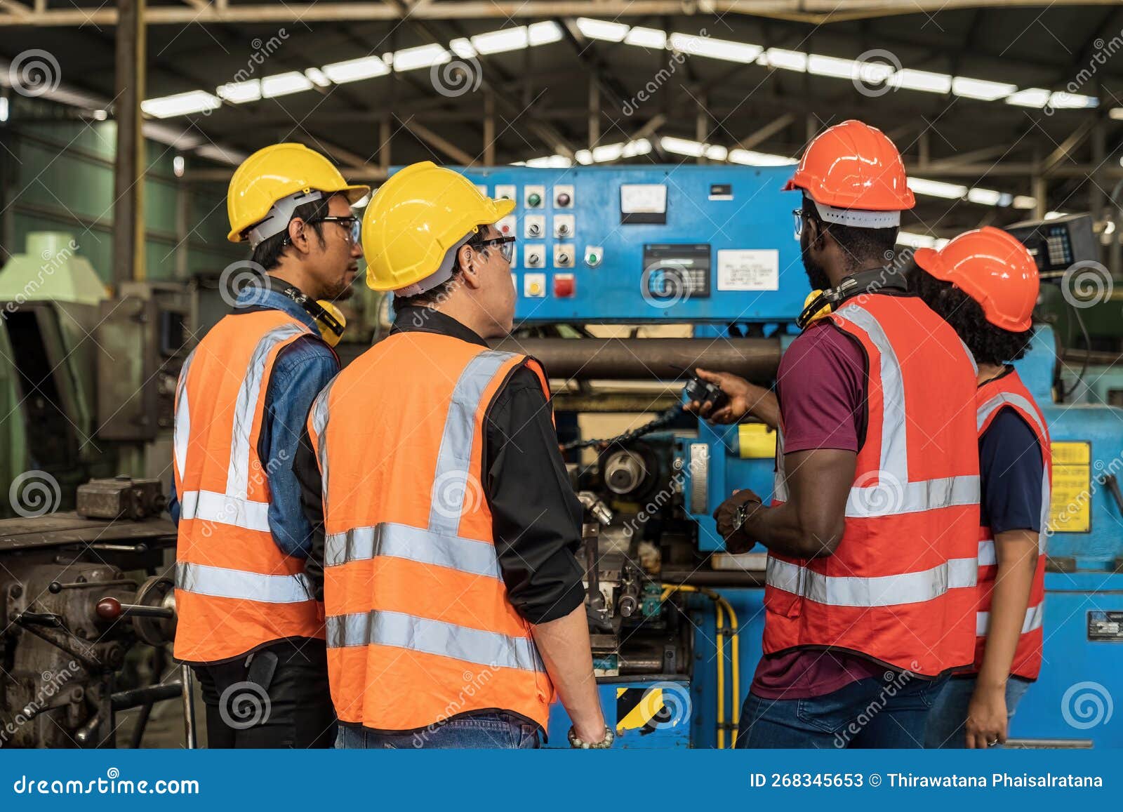 Metal Worker Teaching Trainee on Machine. Engineer Men Wearing Uniform ...
