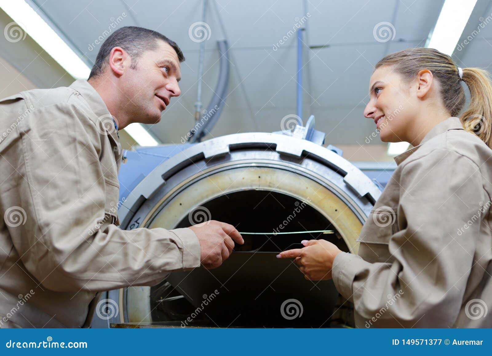Metal Worker Teaching Trainee on Machine Use Stock Image - Image of ...