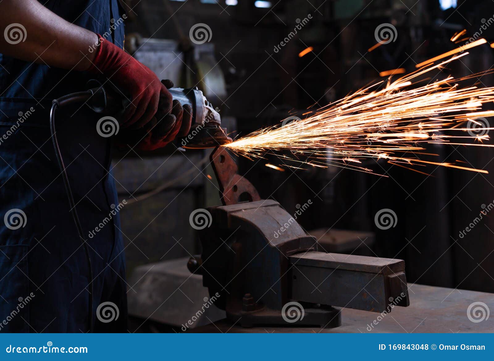 Mechanical Engineer Operating Angle Grinder Cutter in Dark Metal ...