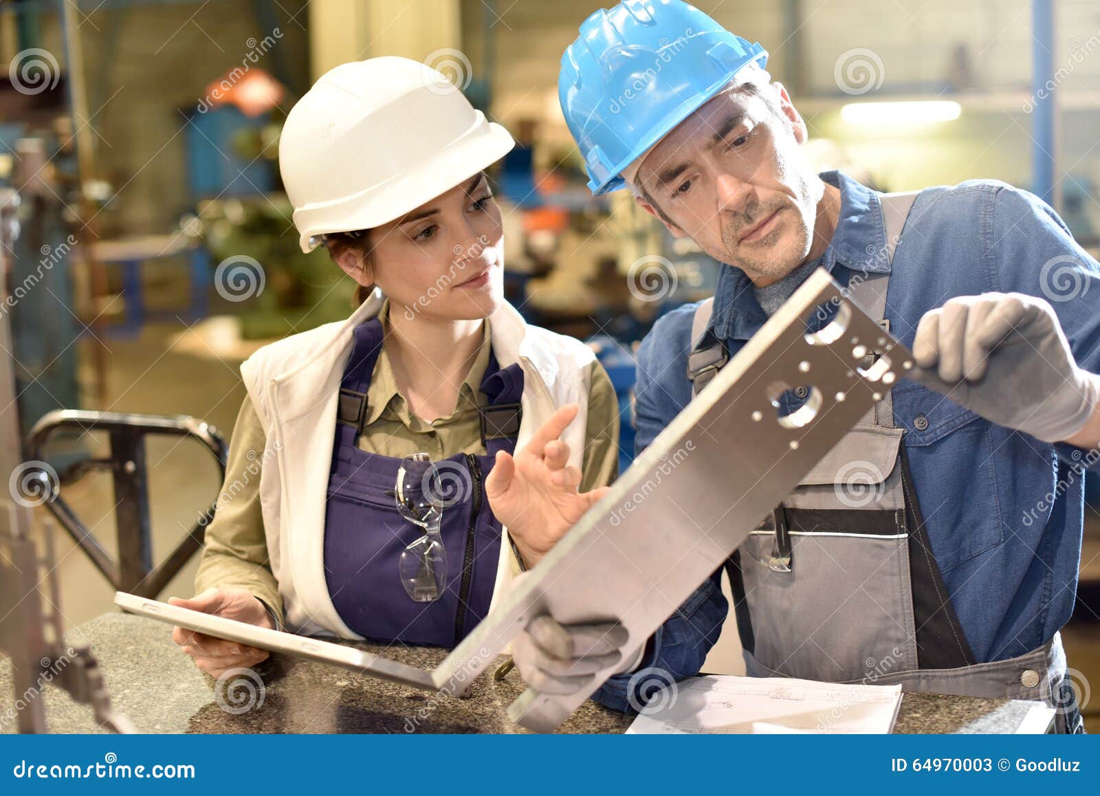 Metal Workers Examining Piece of Metal Stock Image - Image of helmet ...