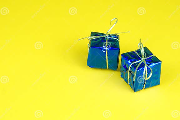 Metallic Blue Present with Silver Strings on a Yellow Background Stock ...