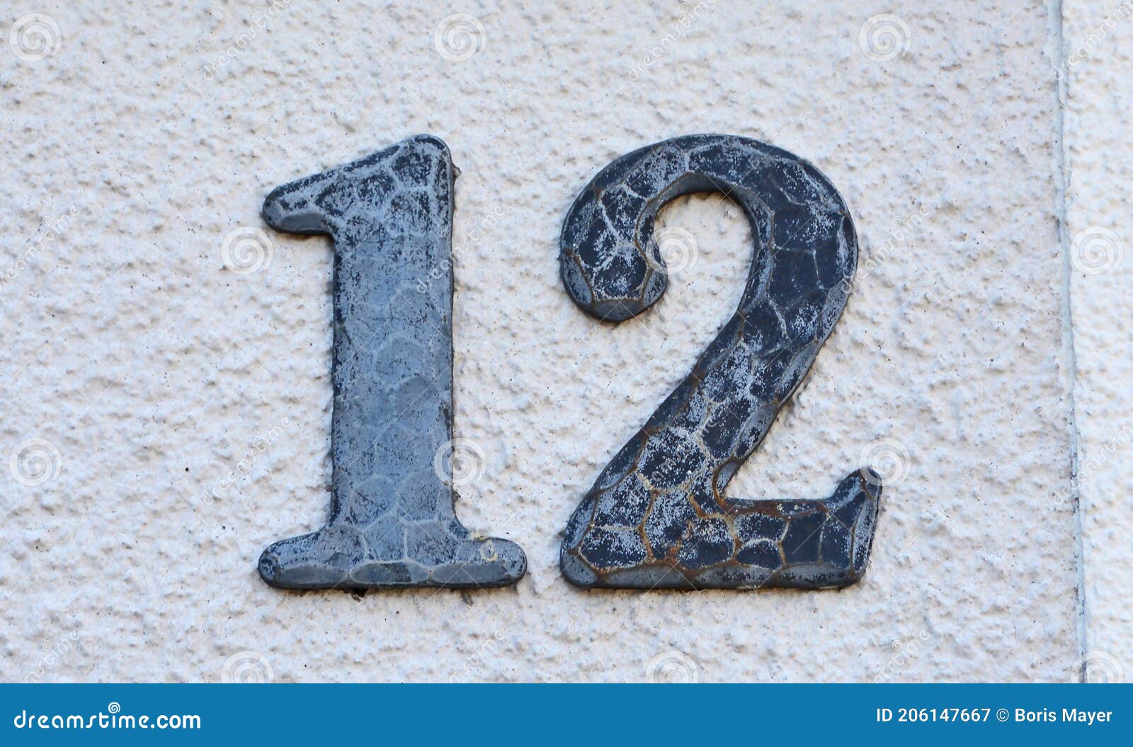 A Metallic Digit Fixed on a Wall and Showing the Number Twelve on a ...