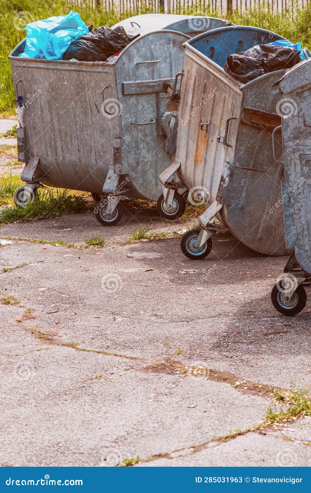 Metallic Garbage Container Filled with Plastic Waste Bags on the Street ...