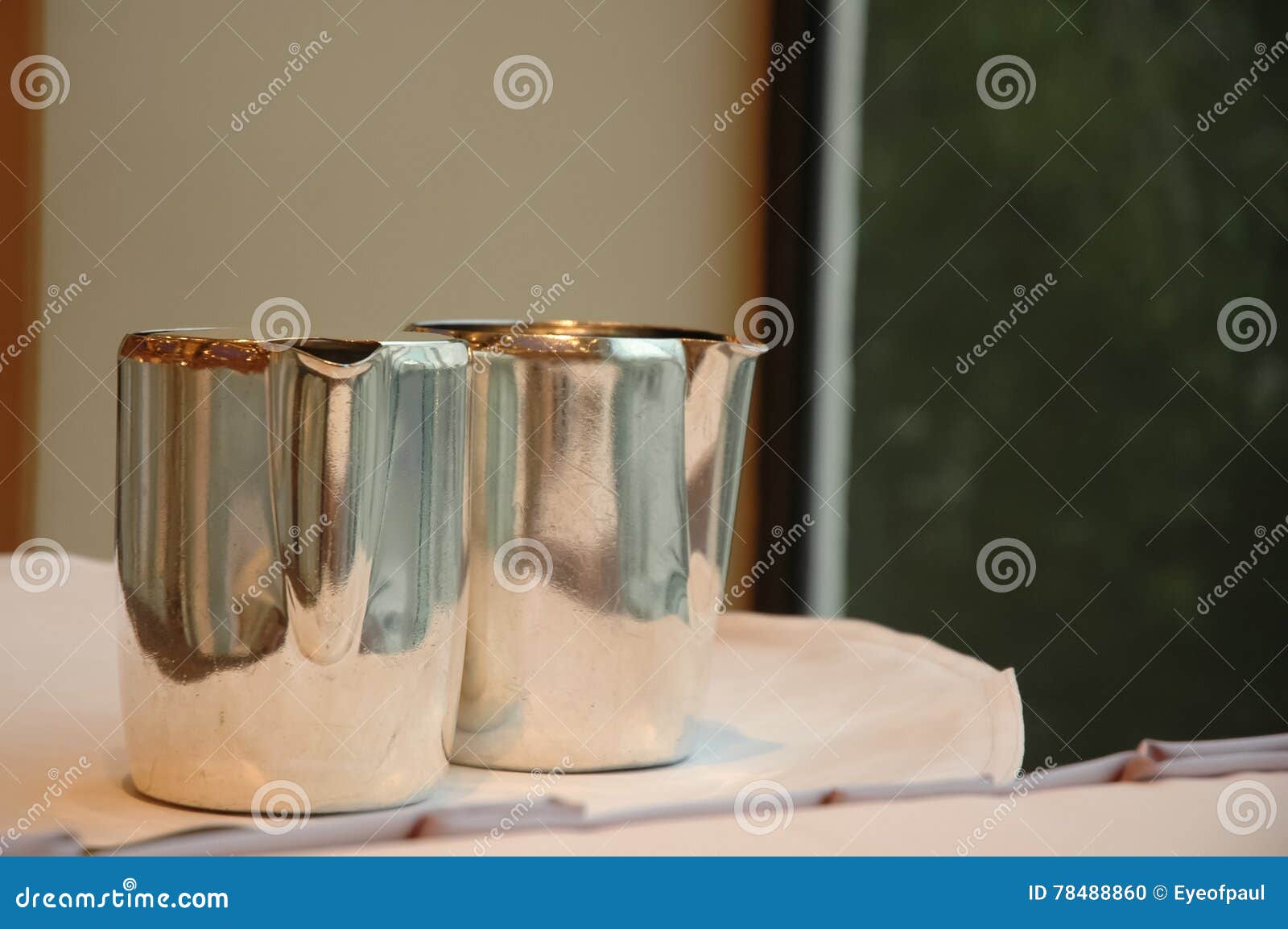 Metallic Jugs on White Table Stock Photo - Image of elegance, metallic ...