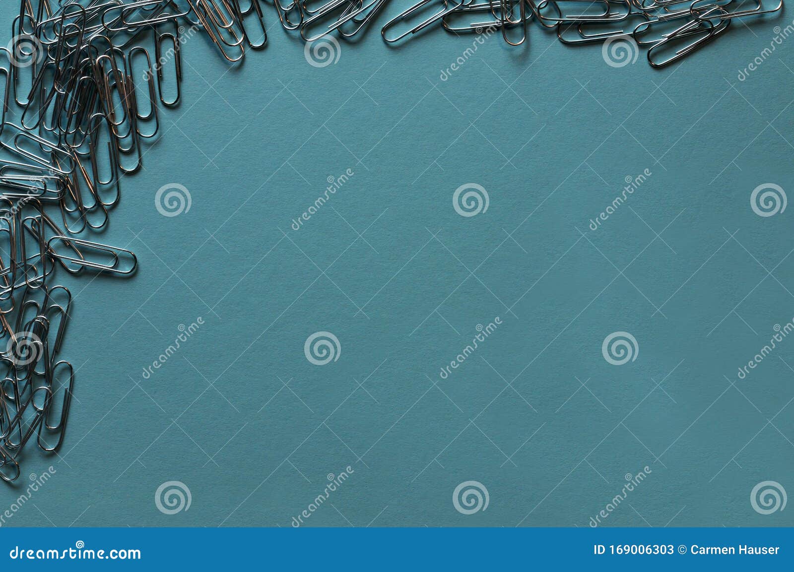 Metallic Paper Clips Lying on a Blue Paper Stock Image - Image of paper ...