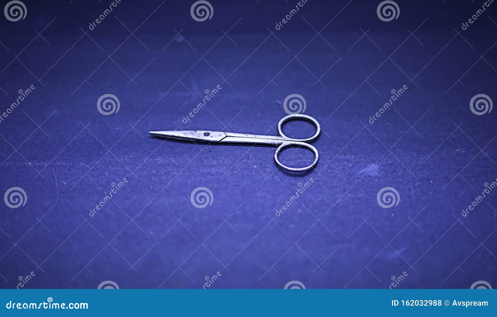 Metallic Scissors for Haircuts with a Blue Handle, Soft Background ...