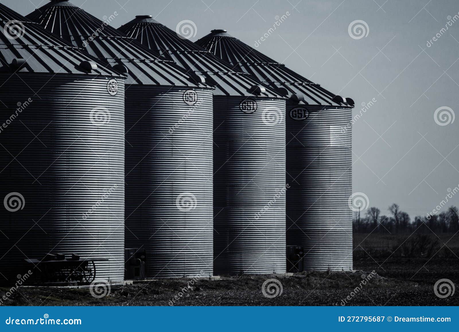 Metallic Storage Silos Standing in a Grassy Meadow Stock Image - Image ...