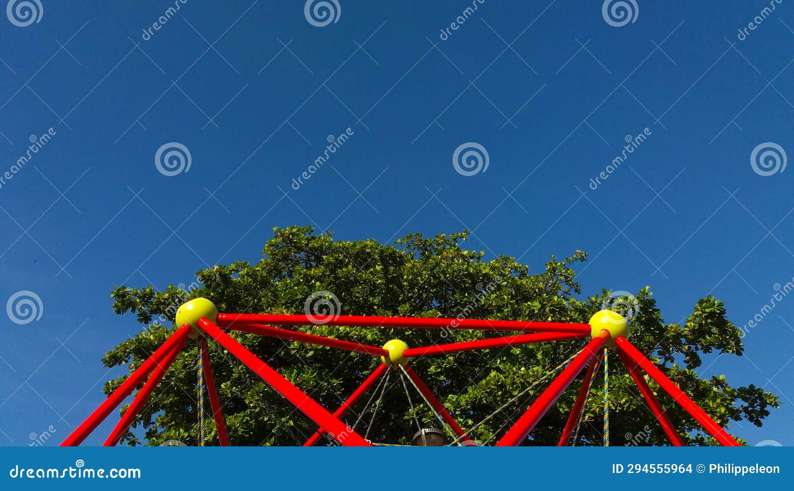 Metallic Structure of Red Beams and Yellow Spheres Over Tree Canopy ...