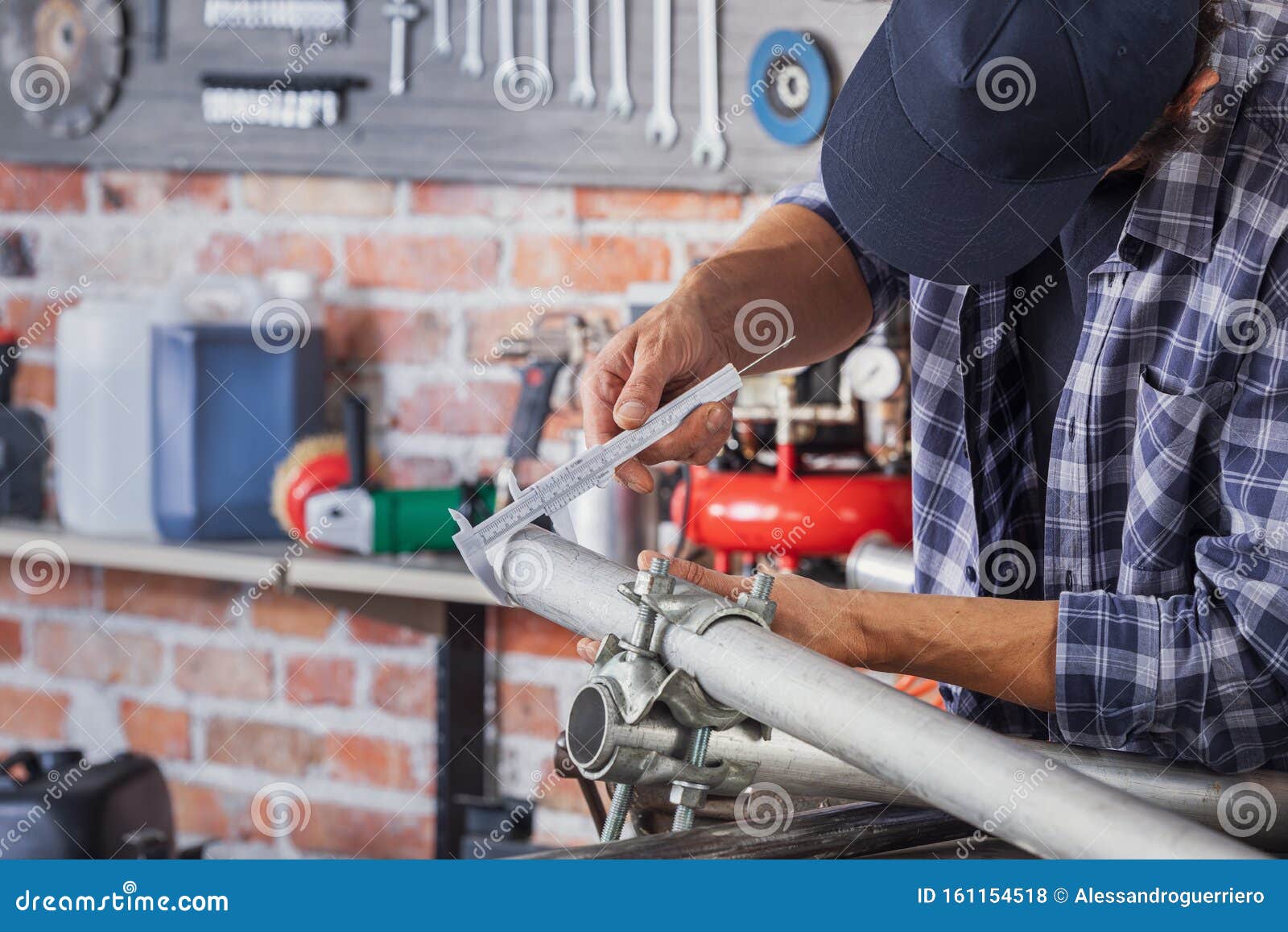 Metalworker Taking Measurements on a Metal Pipe Stock Photo - Image of ...