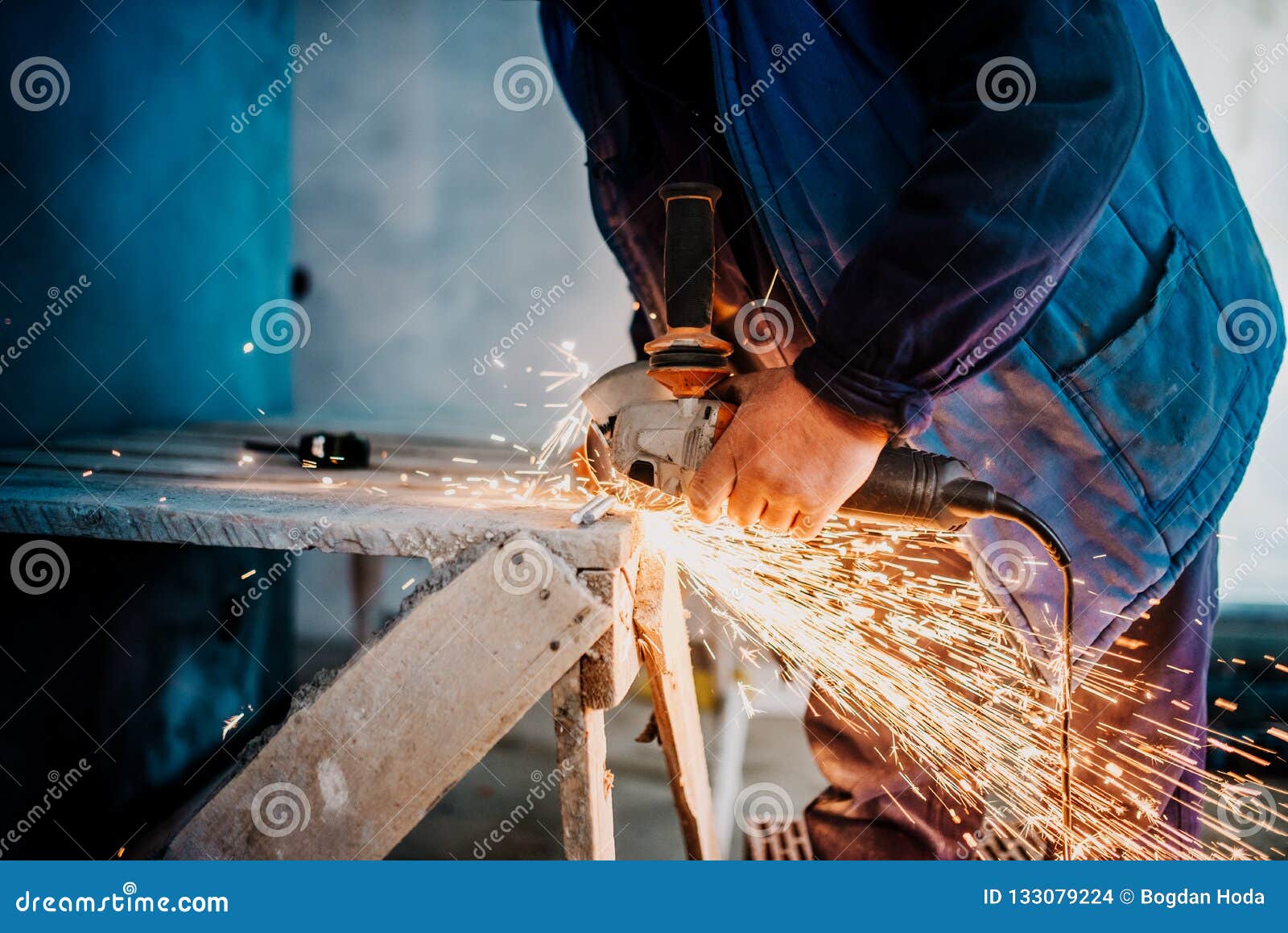 Metalworker Using Small Electrical Grinder and Cutting Metal Stock ...