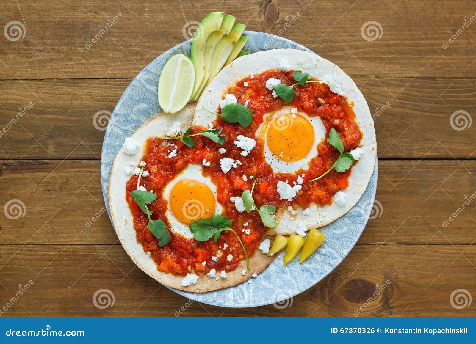 Huevos Rancheros With Crispy Bacon Strips On Blue Ceramic Plate Royalty ...
