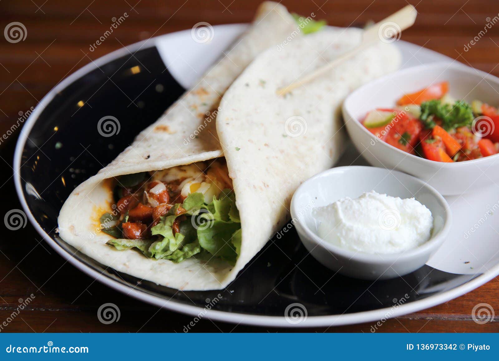 Mexican Burritos on a Plate with Tomato Salad Stock Photo - Image of ...