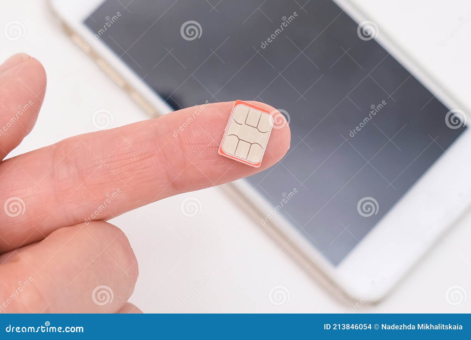 Micro Sim Card for Mobile Communication on a Finger Close Up, Wireless ...