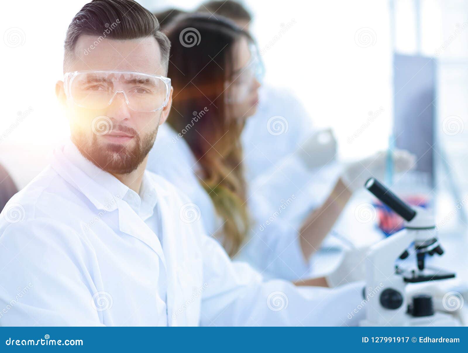 Microbiologist and His Colleagues are Sitting in a Modern Laboratory ...