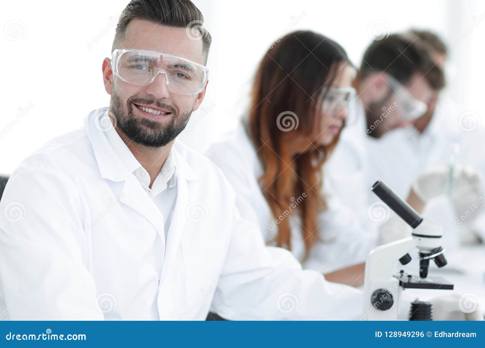 Microbiologist and His Colleagues are Sitting in a Modern Laboratory ...