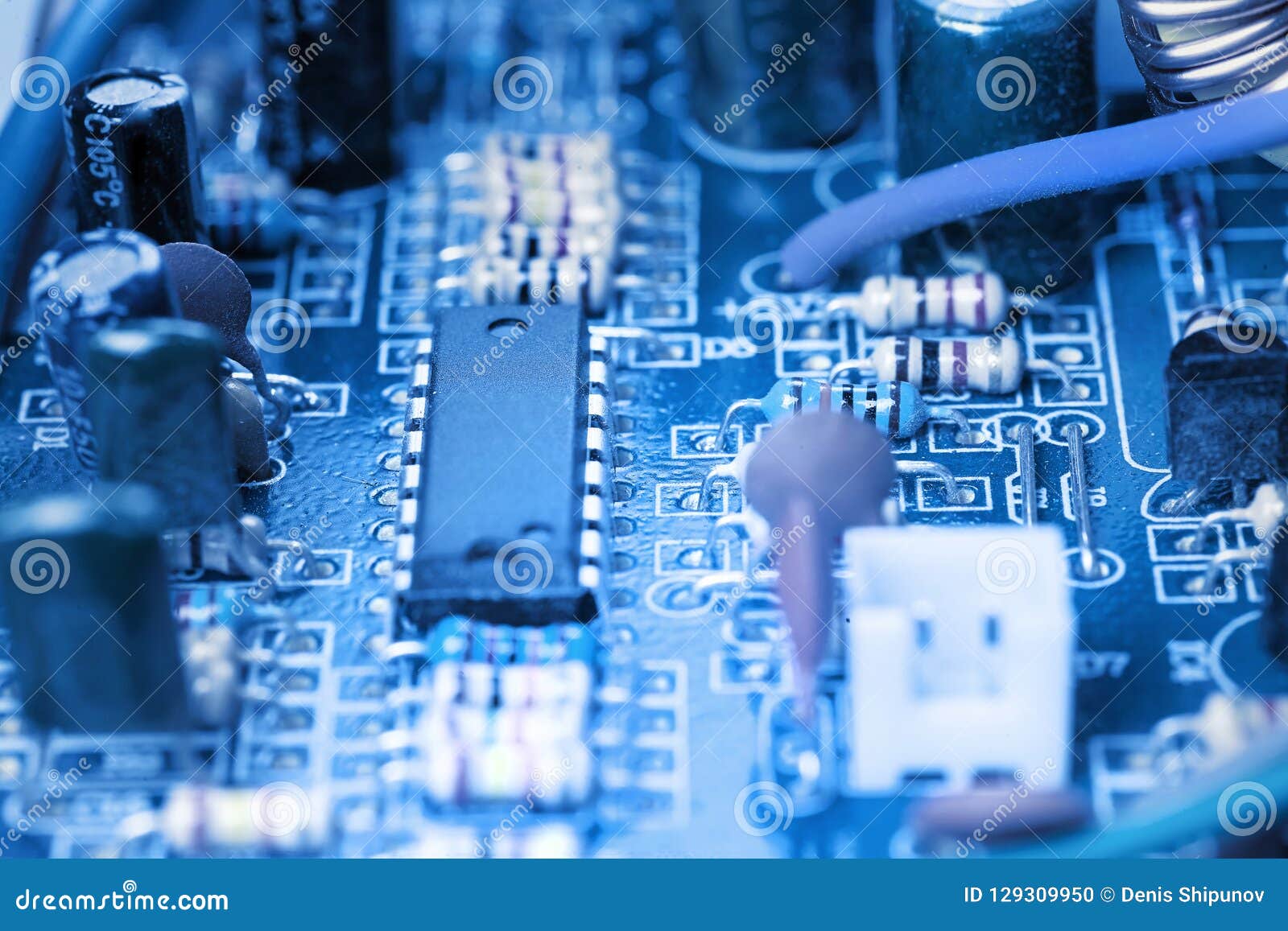 Microchip, Capacitors, Resistors on a Blue Computer Board. Industrial ...