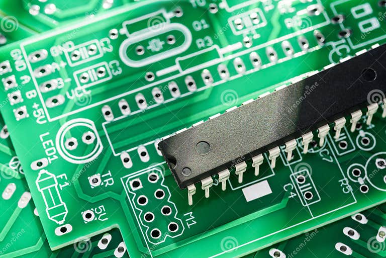 Microchip on a Green Printed Circuit Board with Various Soldering ...