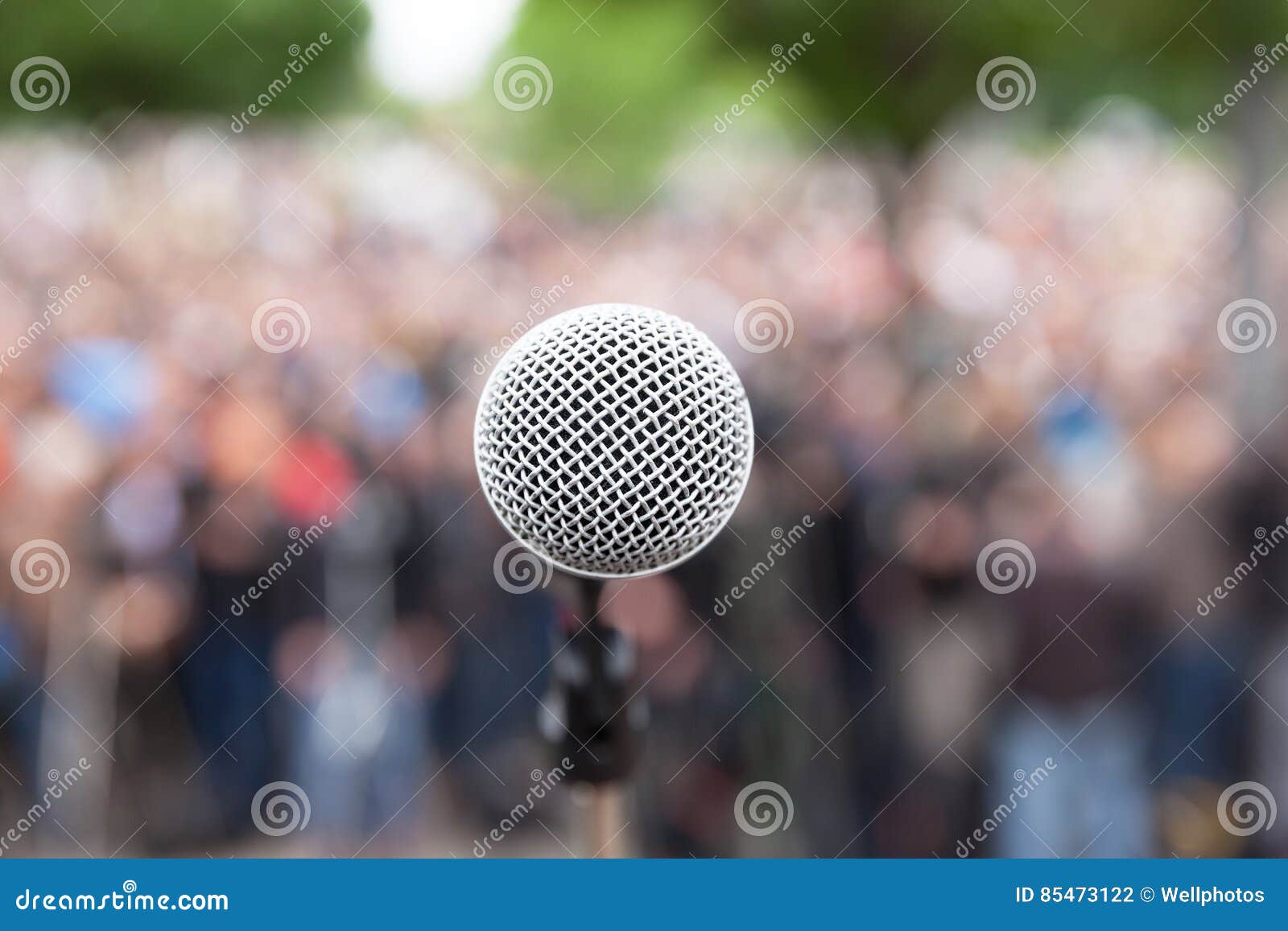 Microphone in Focus Against Blurred Crowd. Political Rally. Stock Photo ...