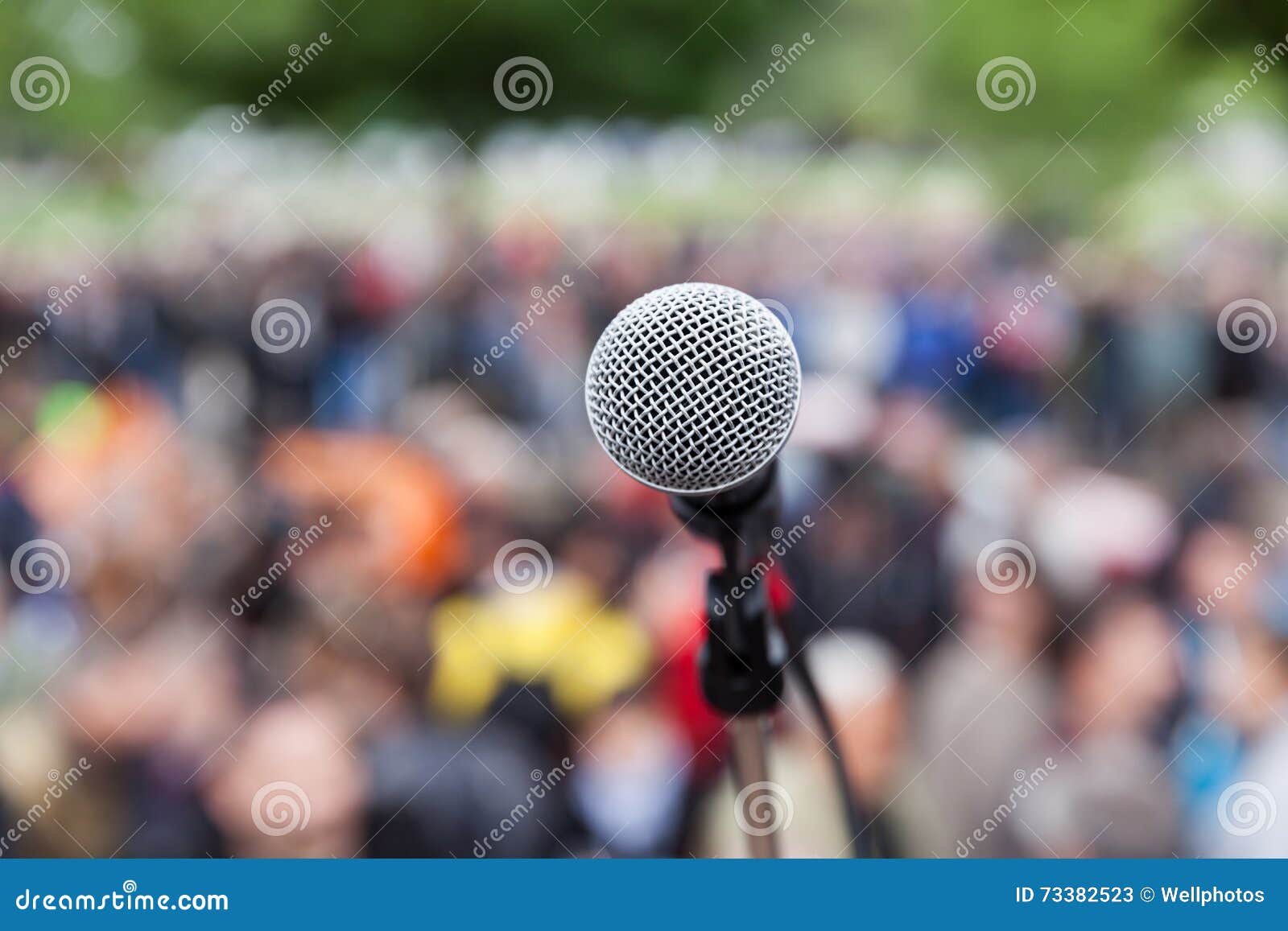 Microphone in Focus Against Blurred Crowd. Protest. Stock Image - Image ...