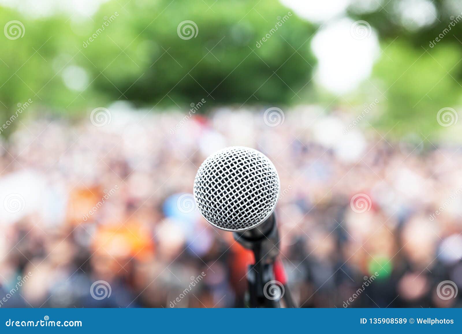 Microphone in Focus Against Blurred Crowd Stock Image - Image of ...