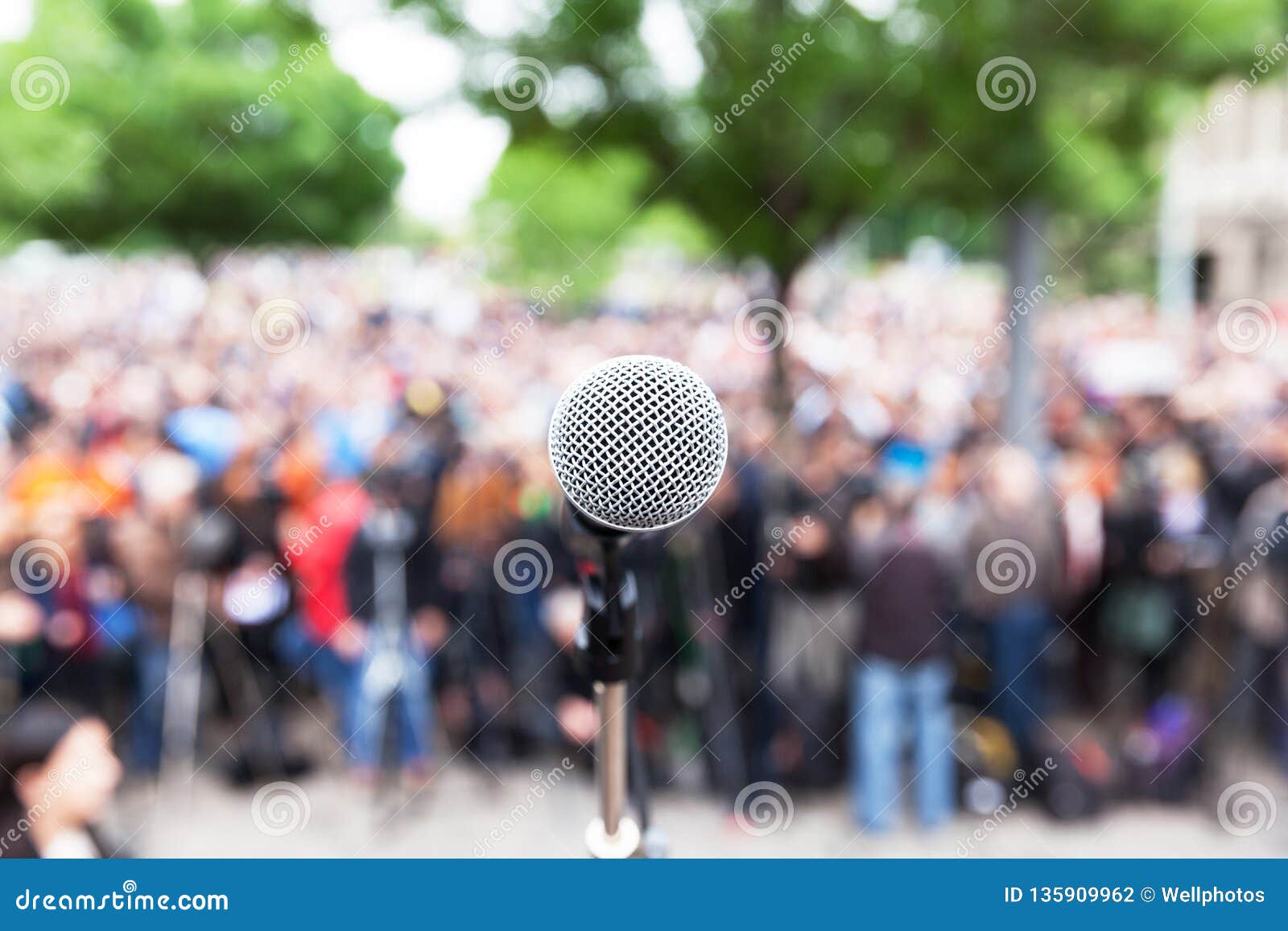 Microphone in Focus Against Blurred Protest or Public Demonstration ...