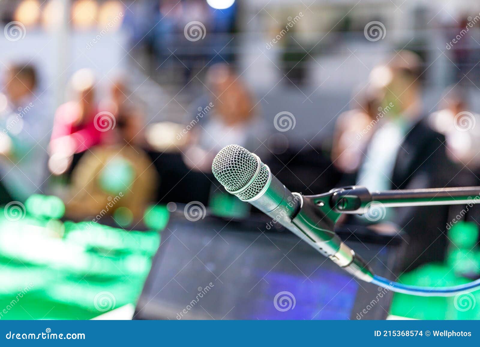 Microphone in Focus, Blurred Audience in the Background Stock Photo ...