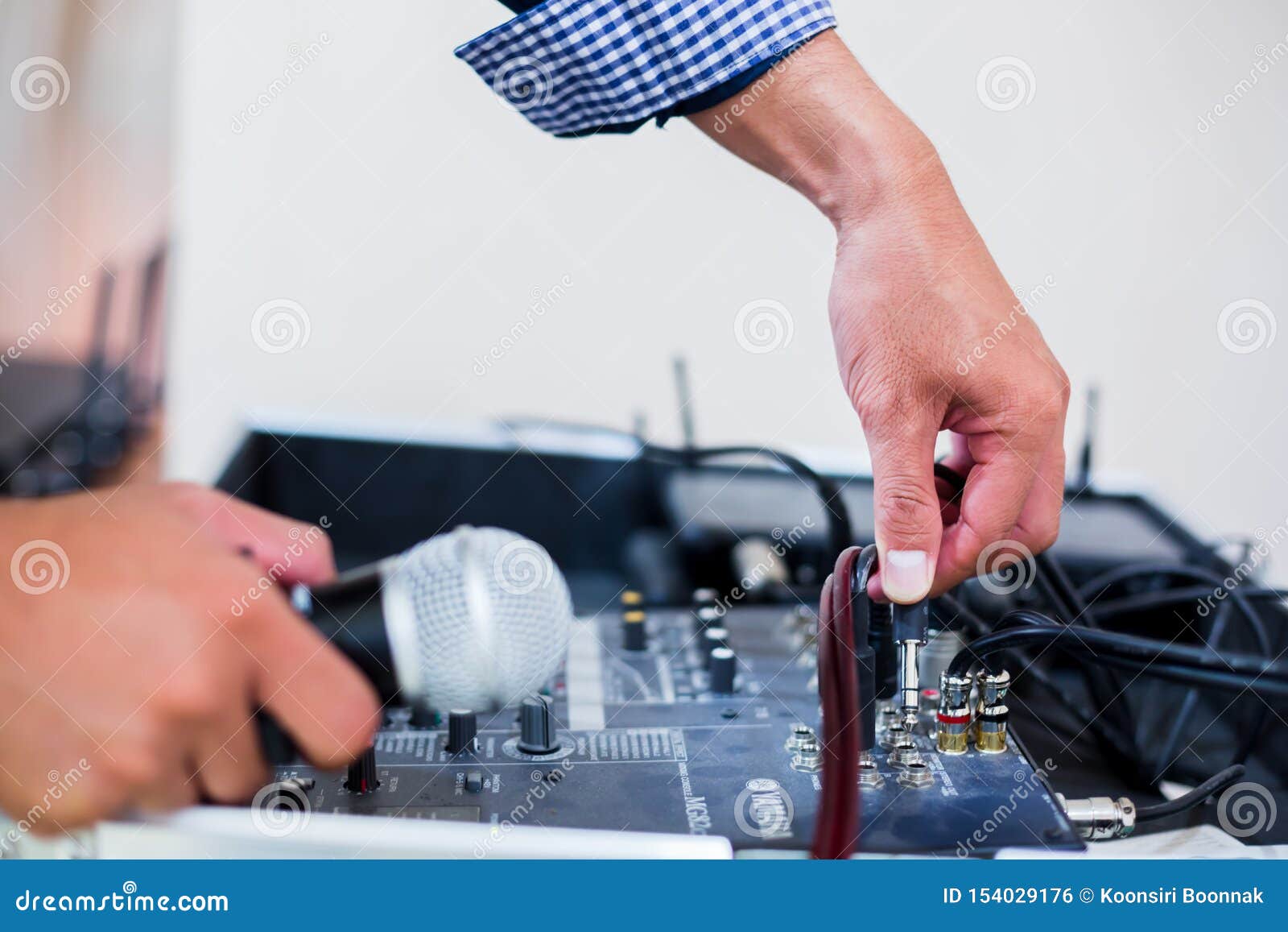 Microphone in Hand and Plugin Audio Jack To Mixer Controller in the ...