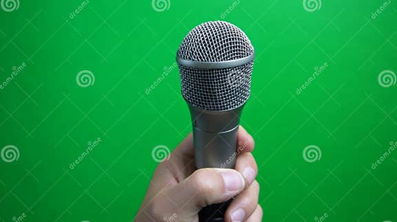 A Microphone is Held Confidently Capturing Every Word Spoken Stock ...