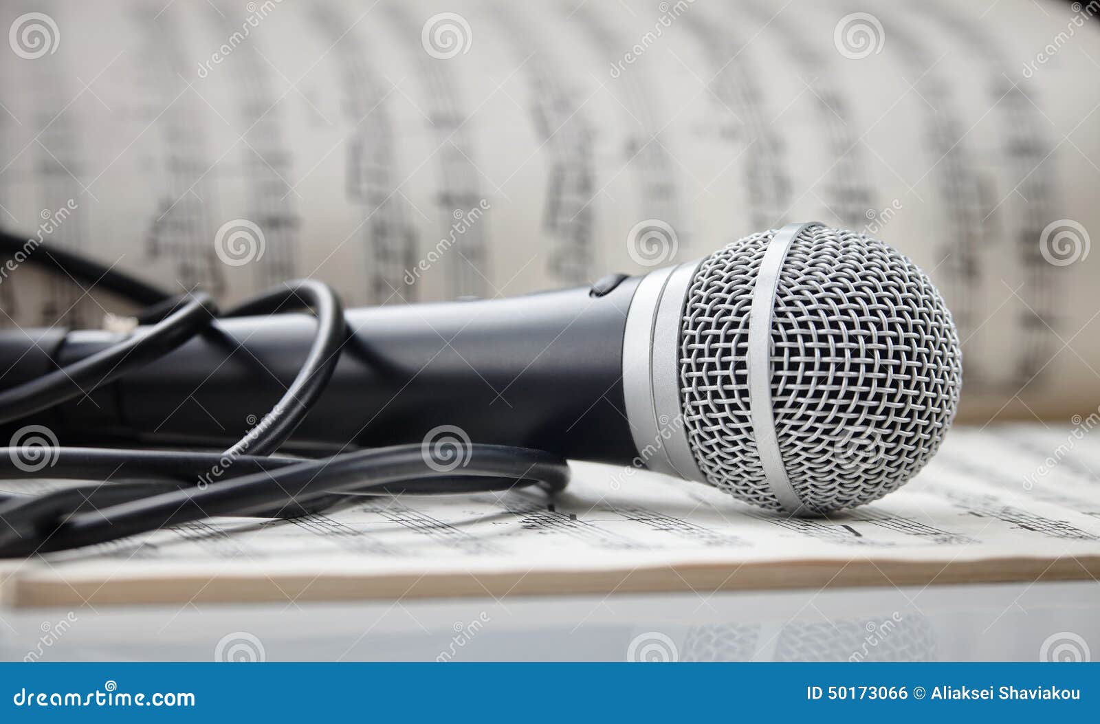 Microphone on sheet music stock photo. Image of notation - 50173066