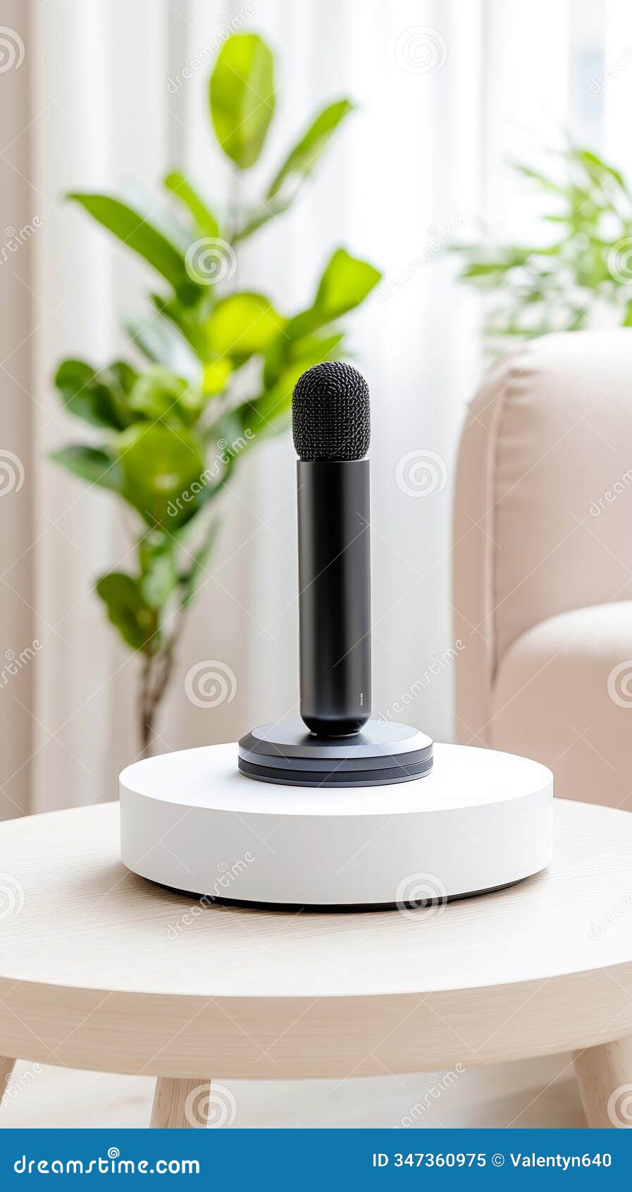 A Microphone Sitting on Top of a Table Next To a Plant Stock Image ...