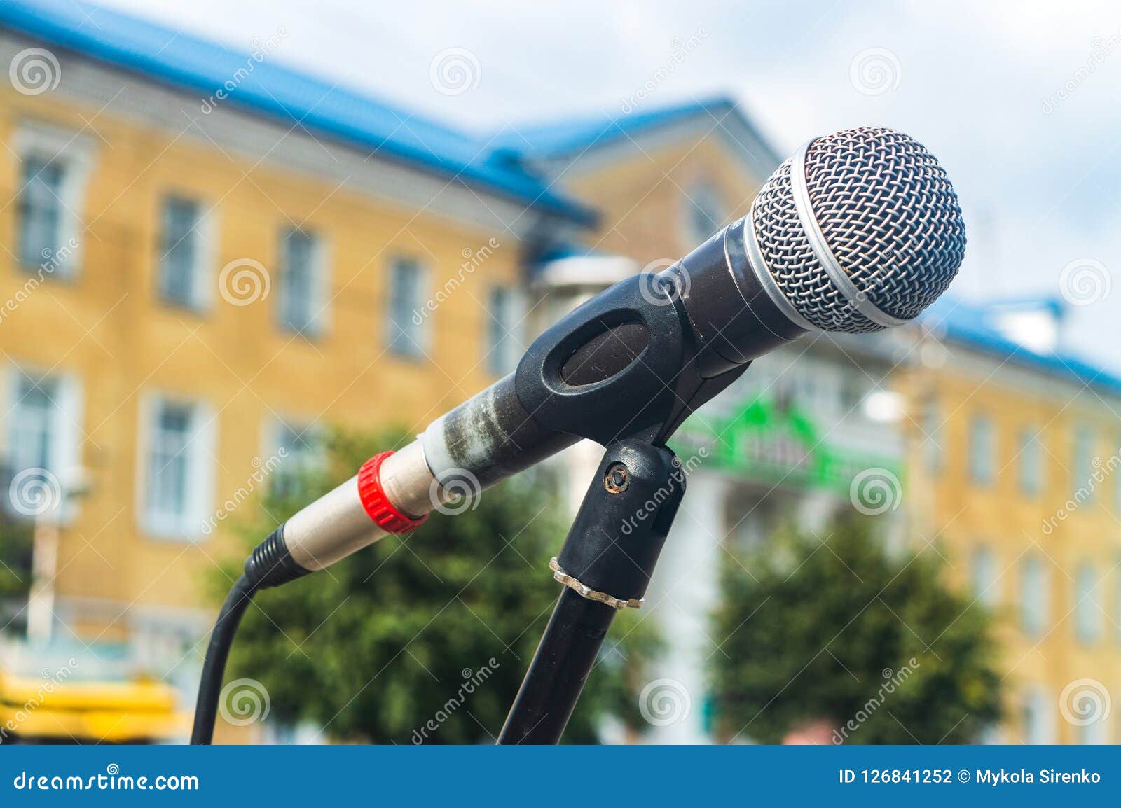 Microphone on a Stand Building in the Background Stock Photo - Image of ...